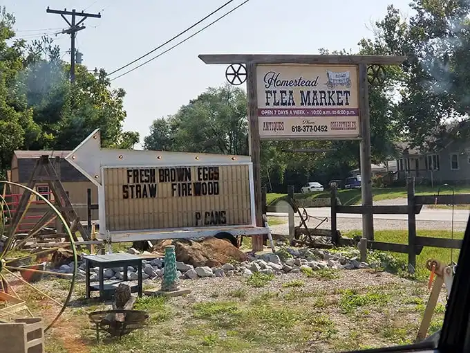 The rustic sign that started countless treasure hunts. Fresh brown eggs advertised alongside antiques—only at Homestead Flea Market.