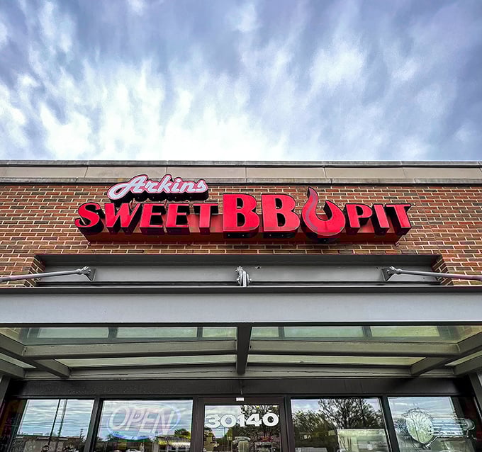 The sign glows like a barbecue beacon against Michigan skies, promising smoky delights that transcend the state's reputation for automotive innovation.