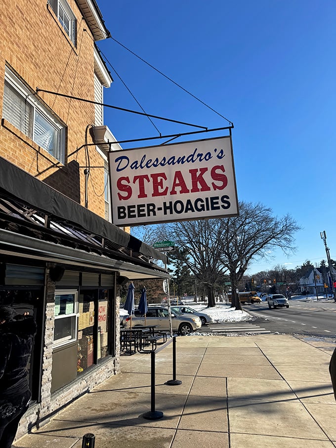 The classic Dalessandro's sign against a blue sky – a beacon of hope for the hungry, a landmark for the locals, and a promise of deliciousness.