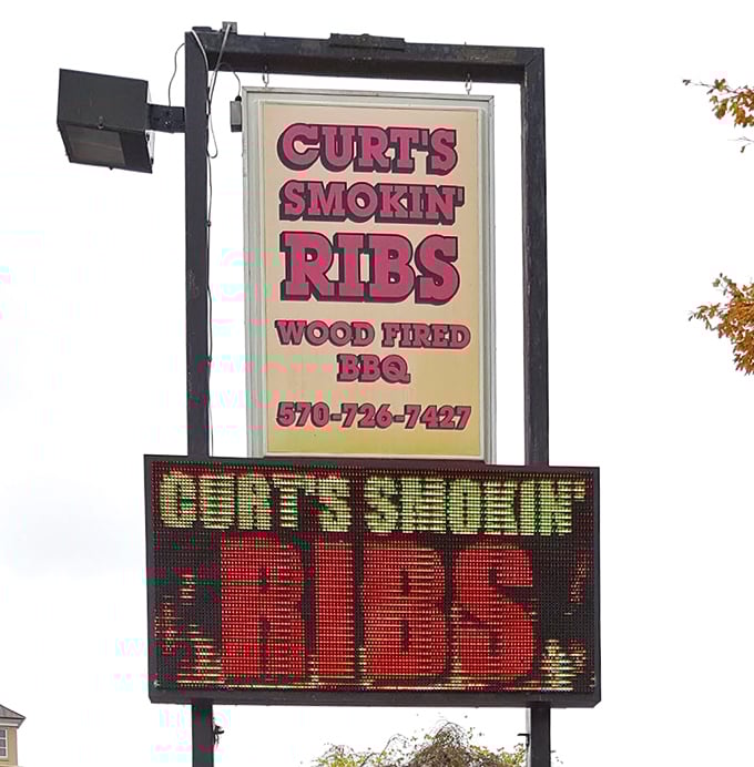 The sign says it all – "Cert's Smokin' Ribs" isn't just a name, it's a factual statement about what's happening inside this barbecue sanctuary.