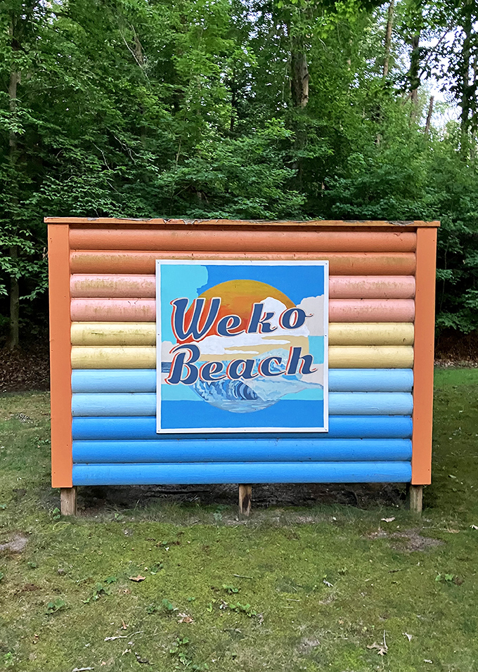 The colorful welcome sign promises exactly what it delivers – a beach experience that feels like a warm hug from Michigan itself.