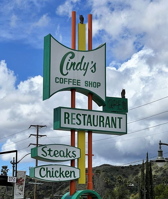 The vintage roadside sign stands tall against the California sky—a beacon of hope for hungry travelers and neighborhood regulars alike.
