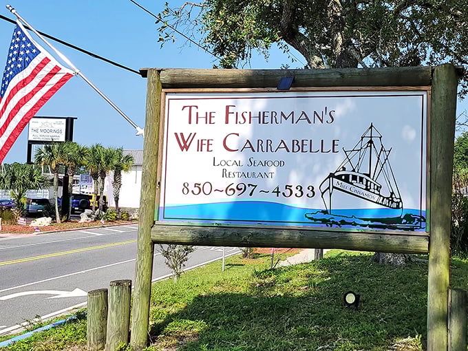 The roadside sign stands like a beacon of hope for hungry travelers. When you see that fishing boat logo, you know you've found the real Florida.
