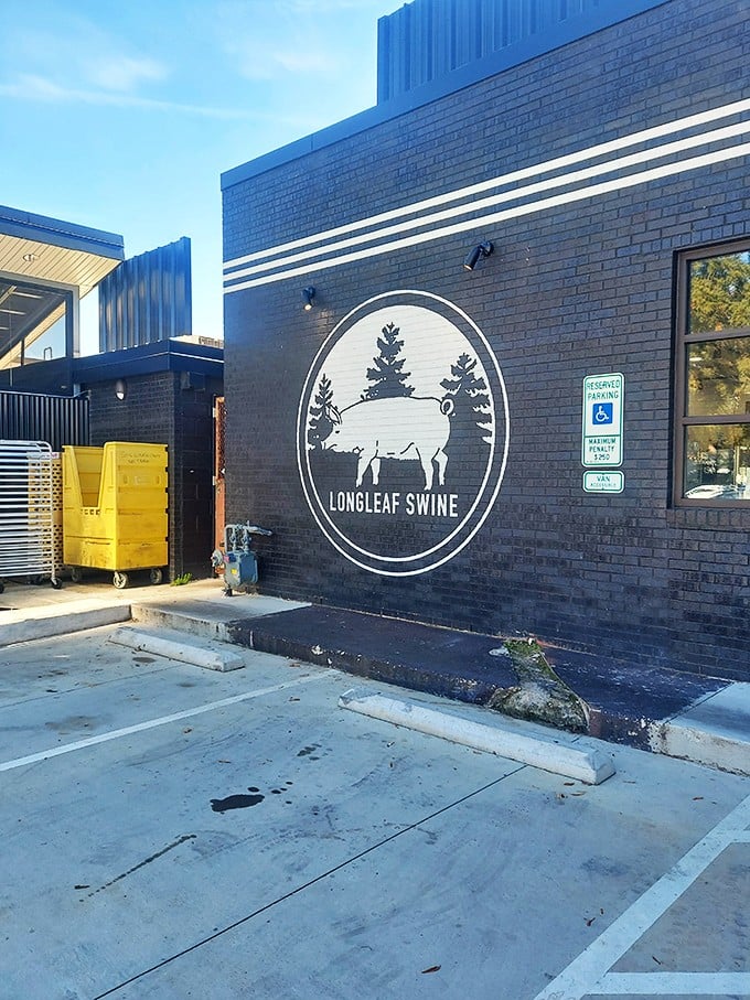 The iconic logo on black brick – two trees and a pig that tell you everything you need to know about Longleaf's commitment to place and plate.