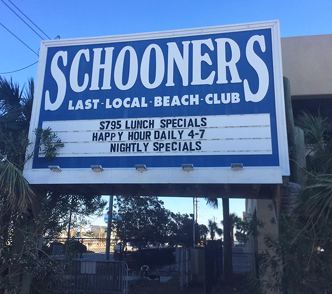 The sign promises lunch specials and happy hour, but what it really advertises is an escape from whatever you left behind at home.
