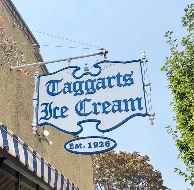 The vintage sign hanging proudly since 1926—a blue and white promise that some traditions are worth preserving in an ever-changing world.