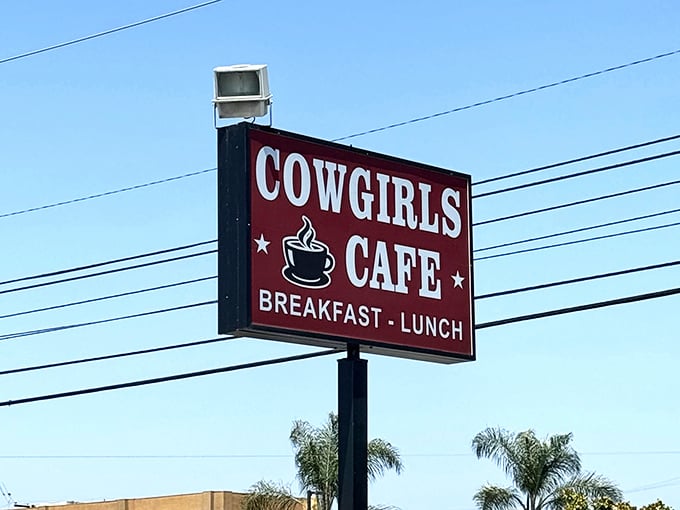 The roadside sign stands tall against the California sky, a beacon of breakfast hope for hungry travelers on busy streets.