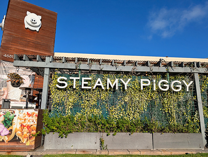 That cheerful piggy logo against a living wall of greenery promises delicious adventures await. Resistance is futile—and unnecessary.