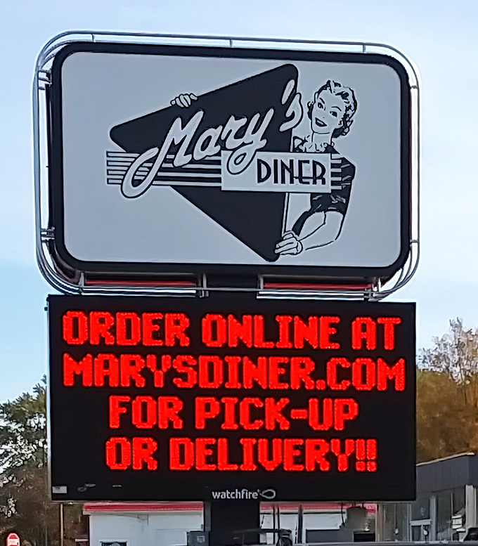 The roadside sign doesn't just advertise—it announces Mary's Diner with mid-century charm while embracing modern convenience with online ordering options.