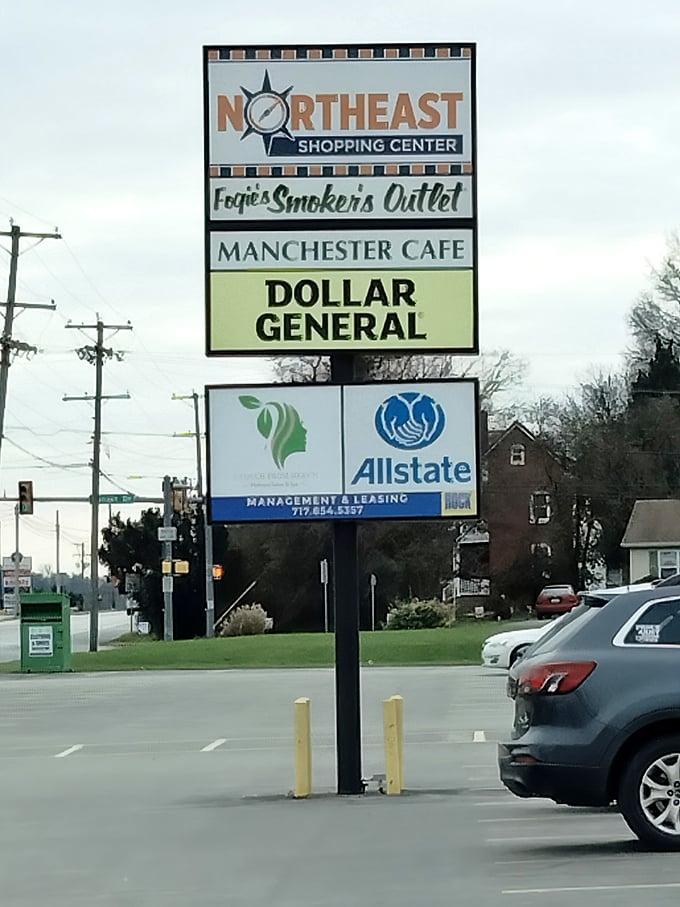 The shopping center sign stands as a beacon for hungry travelers—follow it to find breakfast bliss hiding between Dollar General and Allstate.