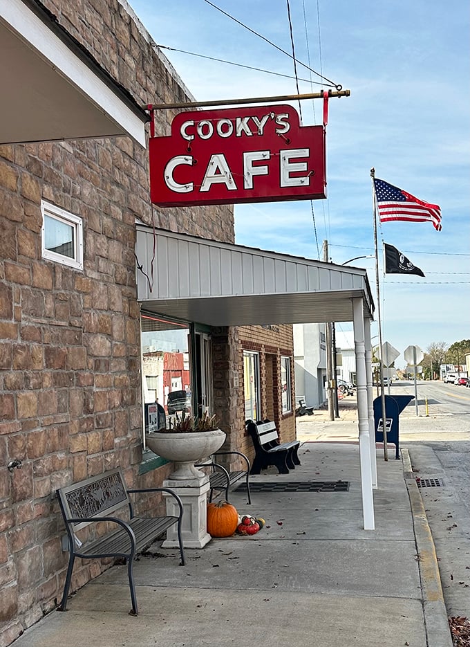 The signature red sign against blue Missouri skies—a small-town landmark that's been guiding hungry travelers to culinary happiness for generations.
