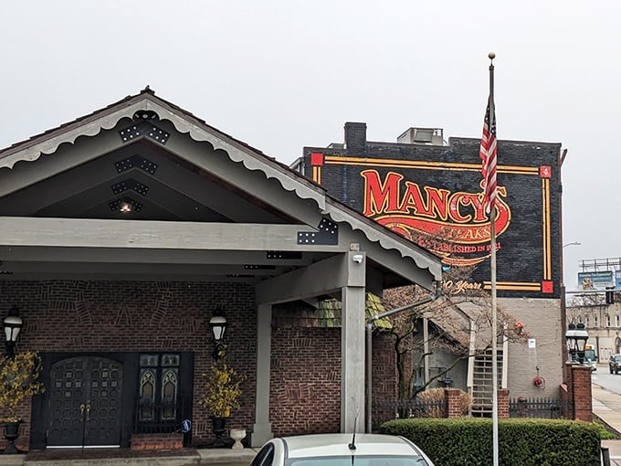 The American flag flies proudly beside that unmistakable Mancy's signage – because great steaks are practically patriotic.