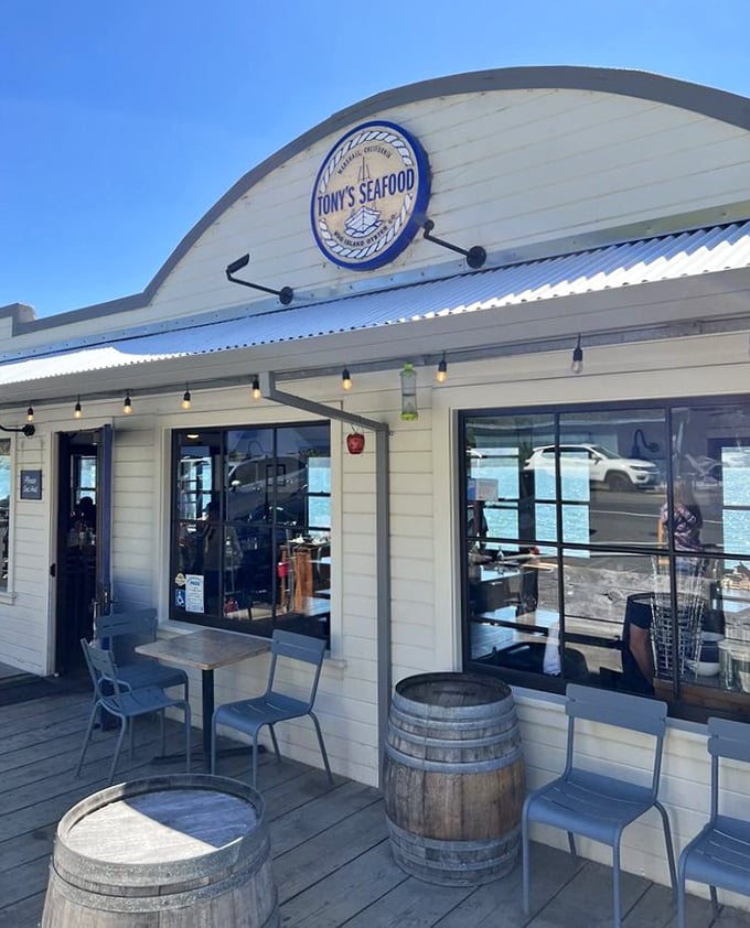 The storefront proudly announces what awaits inside—seafood worth traveling for. Those wine barrels have seen some happy celebrations. 