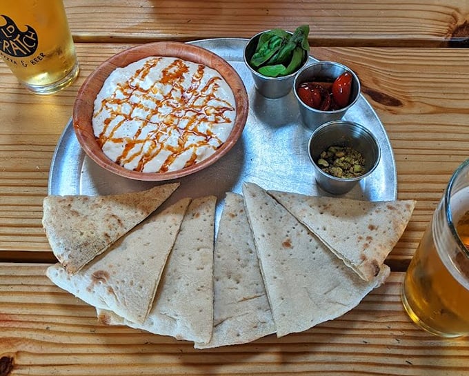 The stracciatella arrives like a deconstructed dream—creamy cheese, warm flatbread, and accompaniments that let you build each perfect bite to your specifications.