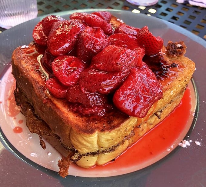 French toast that's having an identity crisis as dessert, topped with strawberries so fresh they're practically introducing themselves to your taste buds.