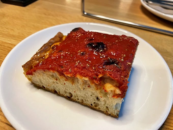 The tomato pie square—thick, focaccia-like, and unapologetically saucy—proves that great pizza doesn't always need to be round.