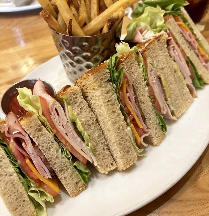 The club sandwich – mankind's greatest achievement in food stacking technology. Perfectly cut triangles prove someone in the kitchen really cares.
