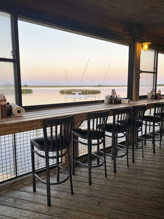 Bar stools facing the water view offer front-row seats to nature's dinner theater—sunsets and sailboats included at no extra charge.