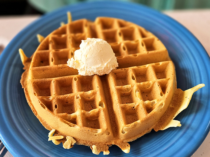 This golden waffle with its perfect butter crown isn't just breakfast—it's what Saturday mornings have aspired to be since childhood.