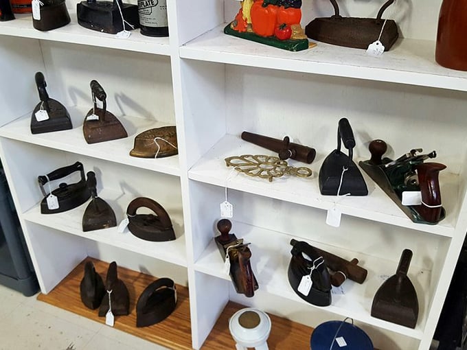 An army of antique irons stands at attention—these heavyweight champions once battled wrinkles in households across America.