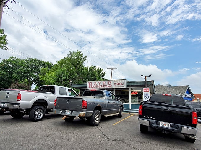 The parking lot tells the story—trucks, SUVs, and sedans all united by the universal language of great hamburgers and chili.
