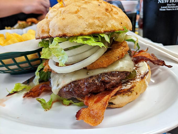 This isn't just a burger—it's an architectural marvel of beef, bacon, and cheese that requires both hands and absolutely zero shame.