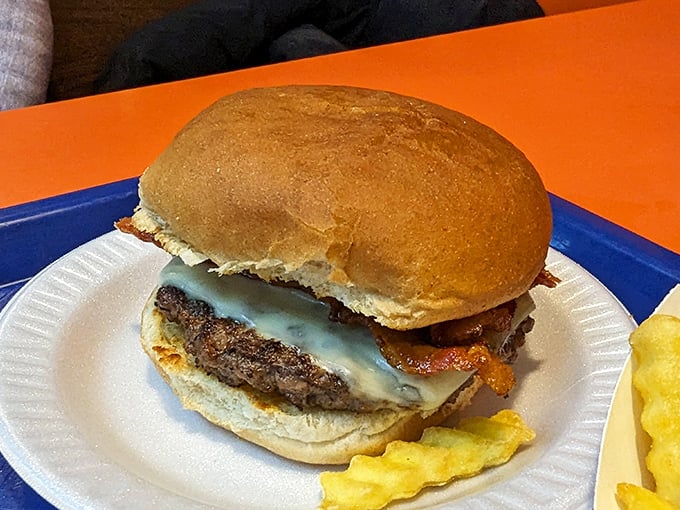 A bacon cheeseburger that makes a compelling argument for simple pleasures. The melted cheese cascading over the patty is pure edible poetry.