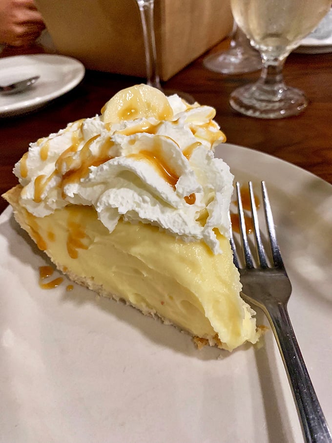 Banana cream pie that makes you consider ordering a second slice before finishing your first—cloud-like whipped cream atop custard that defies physics and willpower.