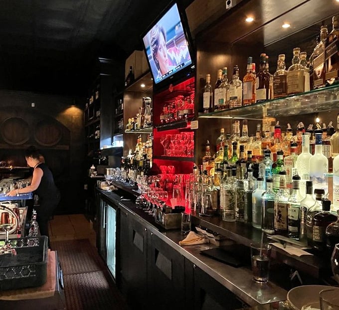 A bar stocked like an Italian grandmother's pantry—if grandma had exceptional taste in premium spirits and a flair for dramatic lighting. 