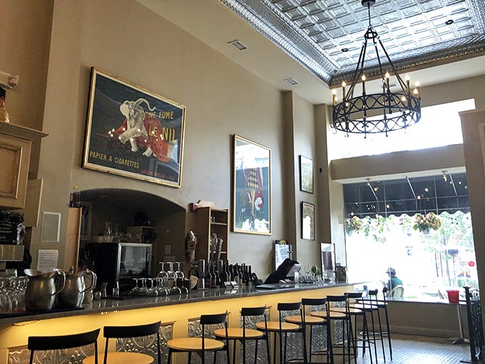 A bar area that invites you to linger over one more glass of wine. Those vintage posters and tin ceiling? They're not trying too hard—they're just right.