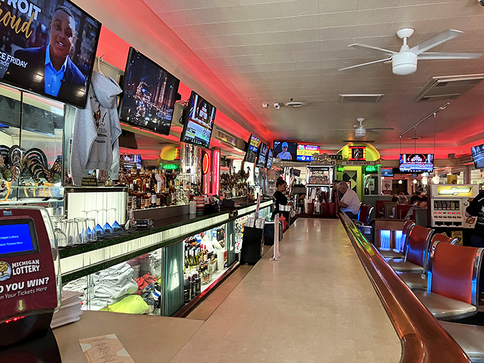 The bar stretches into infinity like a portal to good times. Those red lights aren't just ambiance—they're beacons calling you to unwind. 