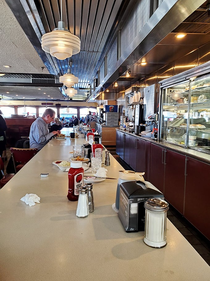 The counter seating—where solo diners become temporary family and the coffee refills flow like conversation.