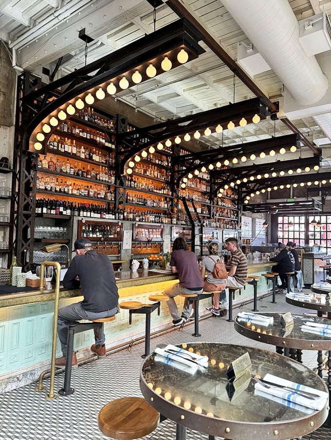 The bar at Ironside isn't just a place to wait for your table—it's a front-row seat to liquid artistry under the glow of vintage lights.