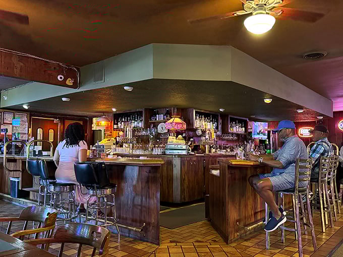 The bar area – where strangers become friends over cold drinks and hot food, proving that the best social networks existed long before the internet.