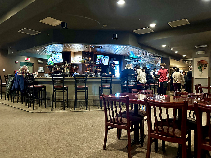 The bar area offers a front-row seat to the mixology magic, perfect for solo diners or those who prefer their steak with a side of social energy.