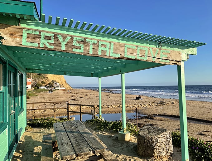 Beachfront dining, Crystal Cove style. This weathered green pergola has witnessed more memorable meals and conversations than any five-star restaurant.