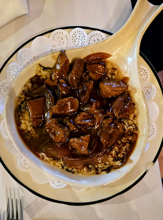 This isn't just beef stew—it's a hearty time machine in a bowl, served on a doily because even comfort food deserves to dress up occasionally.
