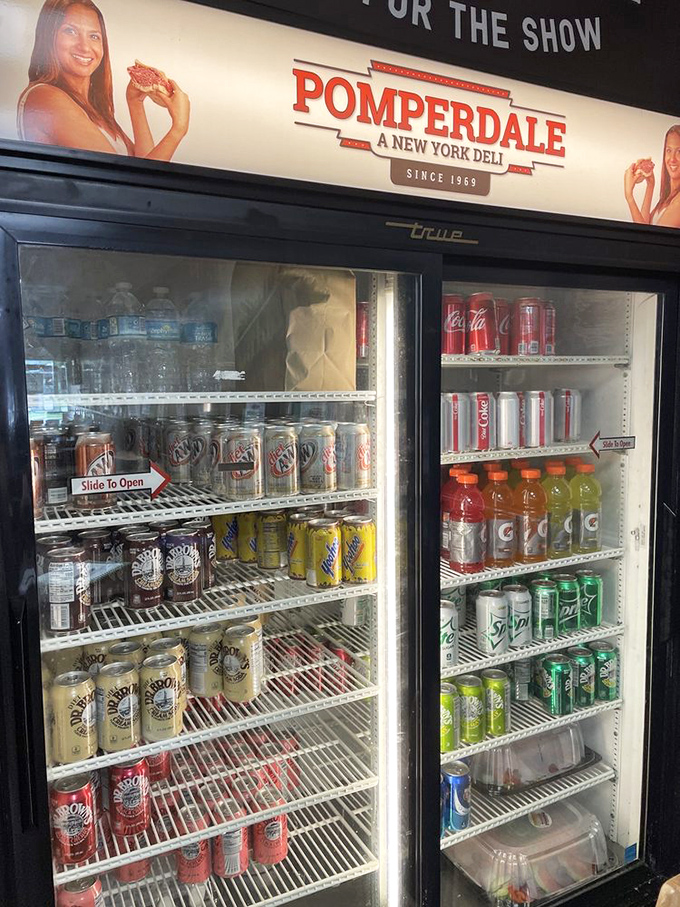 The beverage case—because washing down that pastrami with anything less than a proper Dr. Brown's would be culinary sacrilege.
