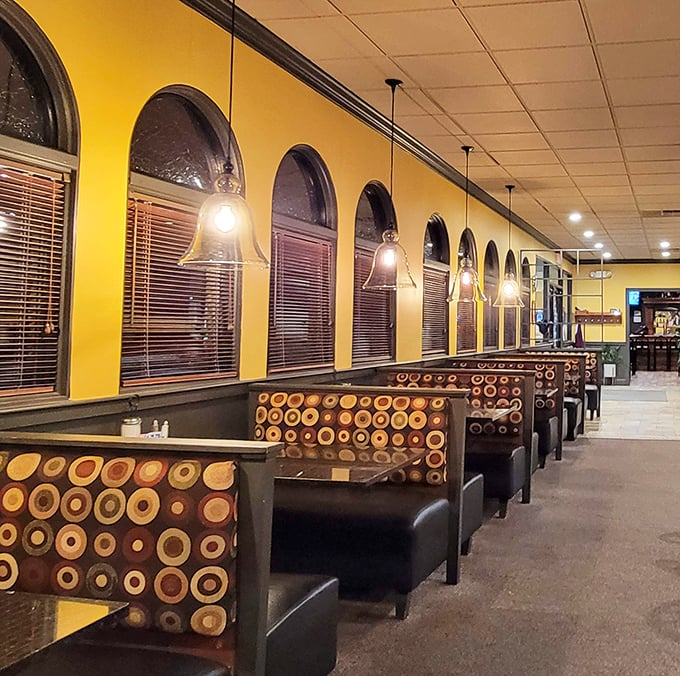 
Cozy booths where food comas are born. Those circular patterns on plush seats invite you to settle in—your diet can always start tomorrow.