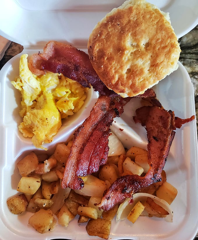 The breakfast platter that launches a thousand productive days—eggs, bacon, potatoes, and a biscuit that defies gravity.