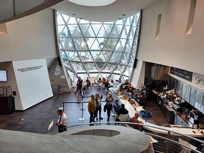 The café's soaring atrium makes lunch feel like dining inside a geometric crystal ball with really good sandwiches.