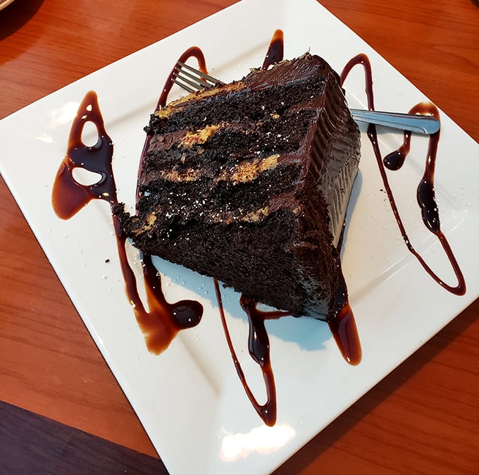 Chocolate cake that doesn't just satisfy your sweet tooth—it throws a party for it, complete with decorative sauce swirls that are practically edible calligraphy.