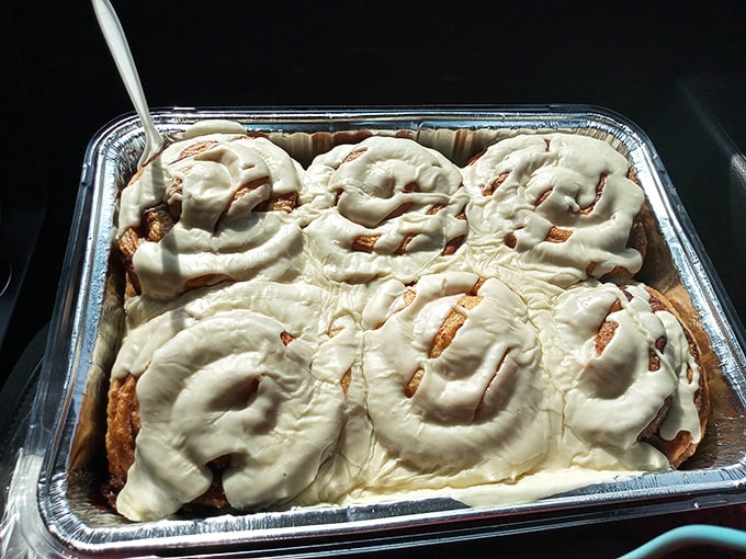 Cinnamon rolls frosted so generously they make you wonder if there was a cream cheese emergency that needed immediate attention.