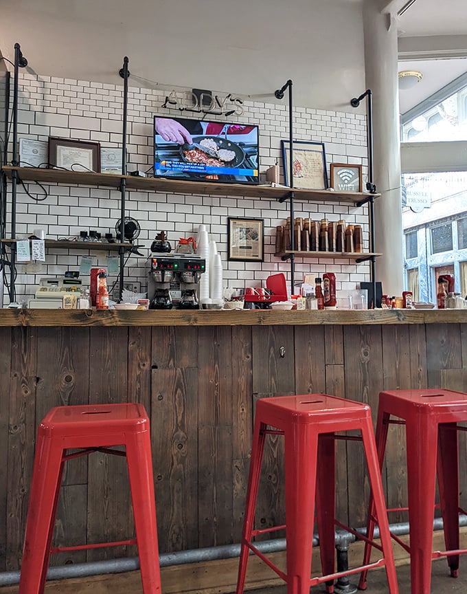 Industrial-chic meets breakfast bar—those red stools aren't just seating, they're front-row tickets to the greatest morning show in Cleveland.