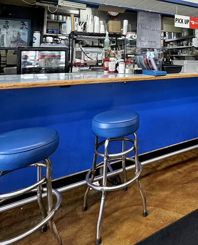 The blue counter and classic stools invite solo diners to perch and watch the breakfast ballet unfold—front-row seats to culinary theater.