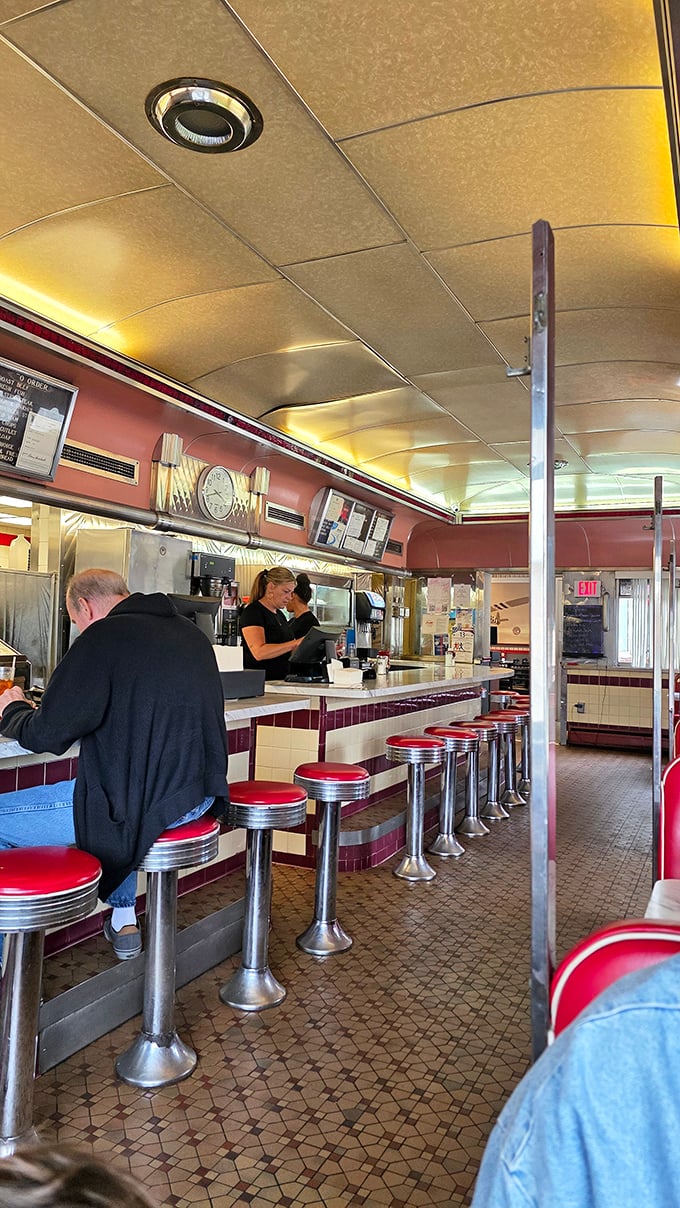 The counter seating—where solo diners become regulars, servers become therapists, and the coffee cup is never allowed to reach empty.