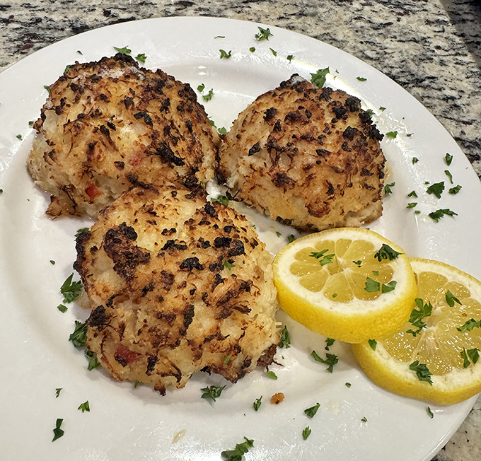 Maryland crab cakes that don't skimp on the crab—a refreshing concept in a world where "crab cake" often means "breadcrumb patty with crab rumors."