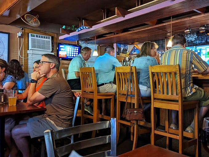 The true measure of any great tavern is its people—regulars and newcomers alike gathering at the bar, united by good food and better company.