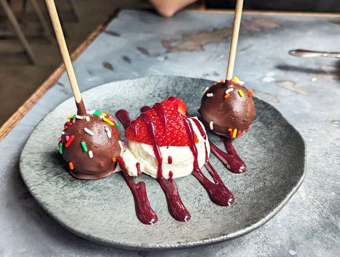 Dessert that doesn't just satisfy your sweet tooth—it entertains it. Chocolate cake pops and a strawberry that dressed up for the occasion.