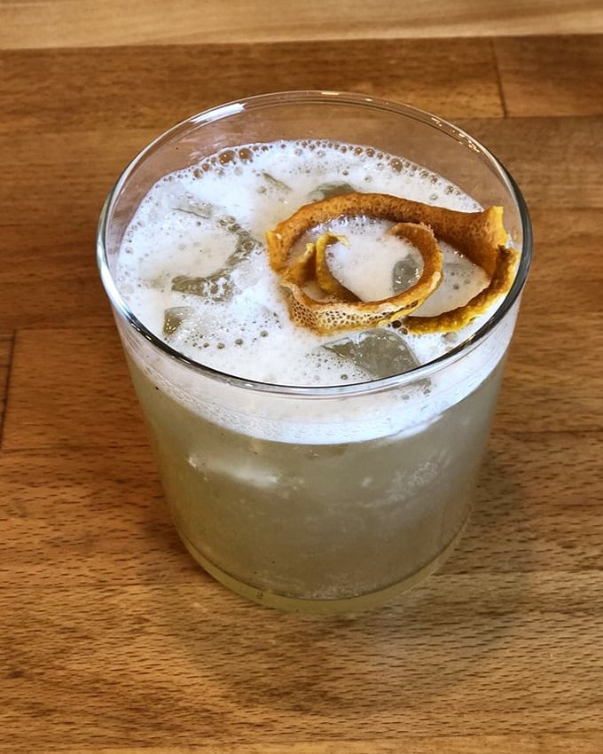 This frothy cocktail with its citrus garnish isn't just a drink—it's liquid art that perfectly balances your rich, hearty Eastern European feast.